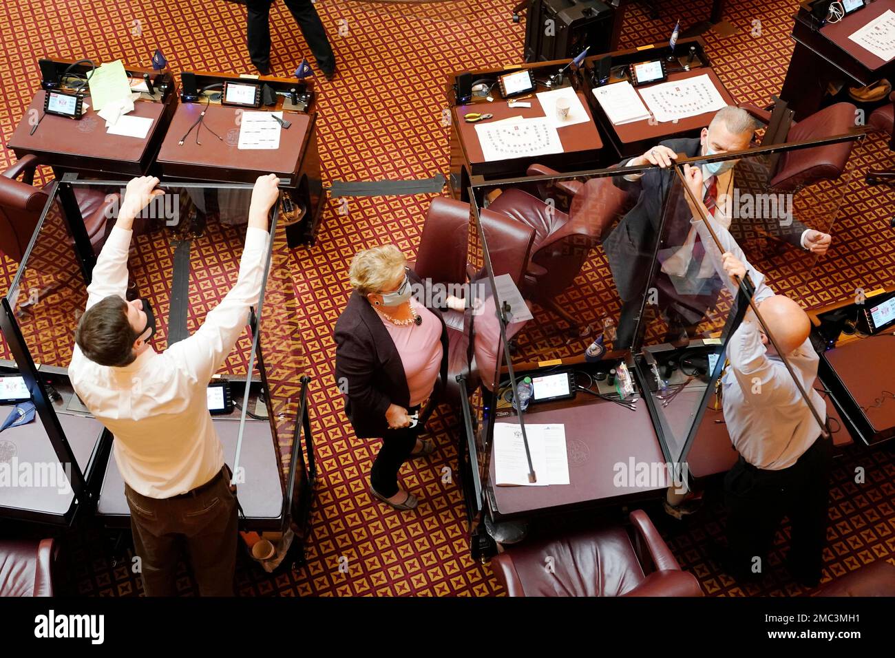 Clerk of the Virginia Senate, Susan Schaar, center, helps remove COVID ...