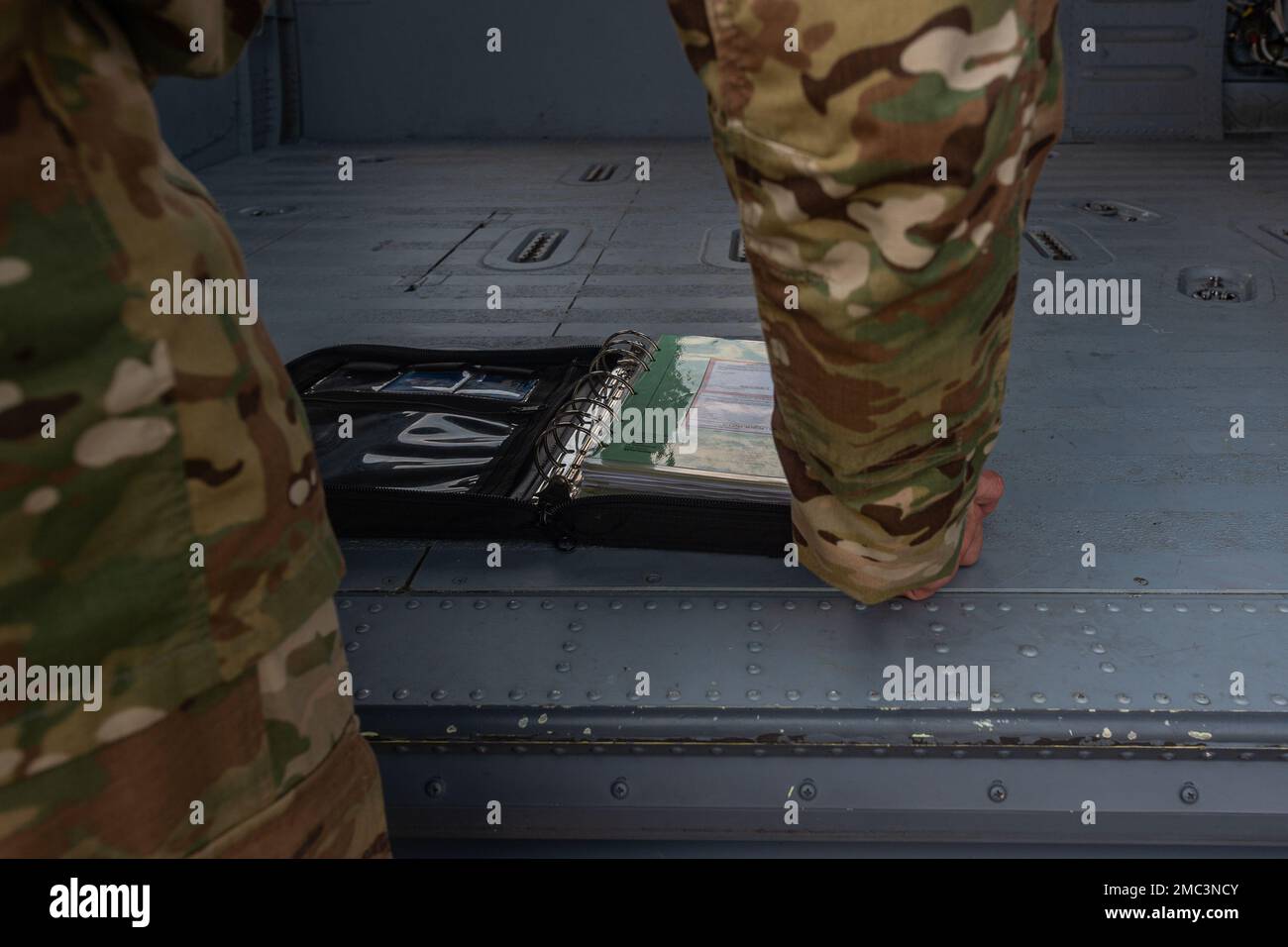 A Top Tiger judge examines a maintenance binder during the quarterly ...