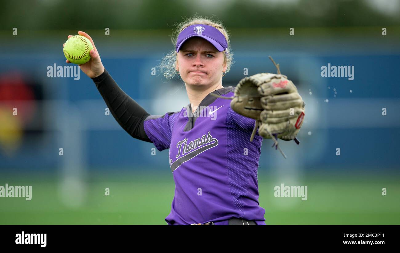 St. Thomas outfielder Kenzie Miller (4) throws during an NCAA softball ...