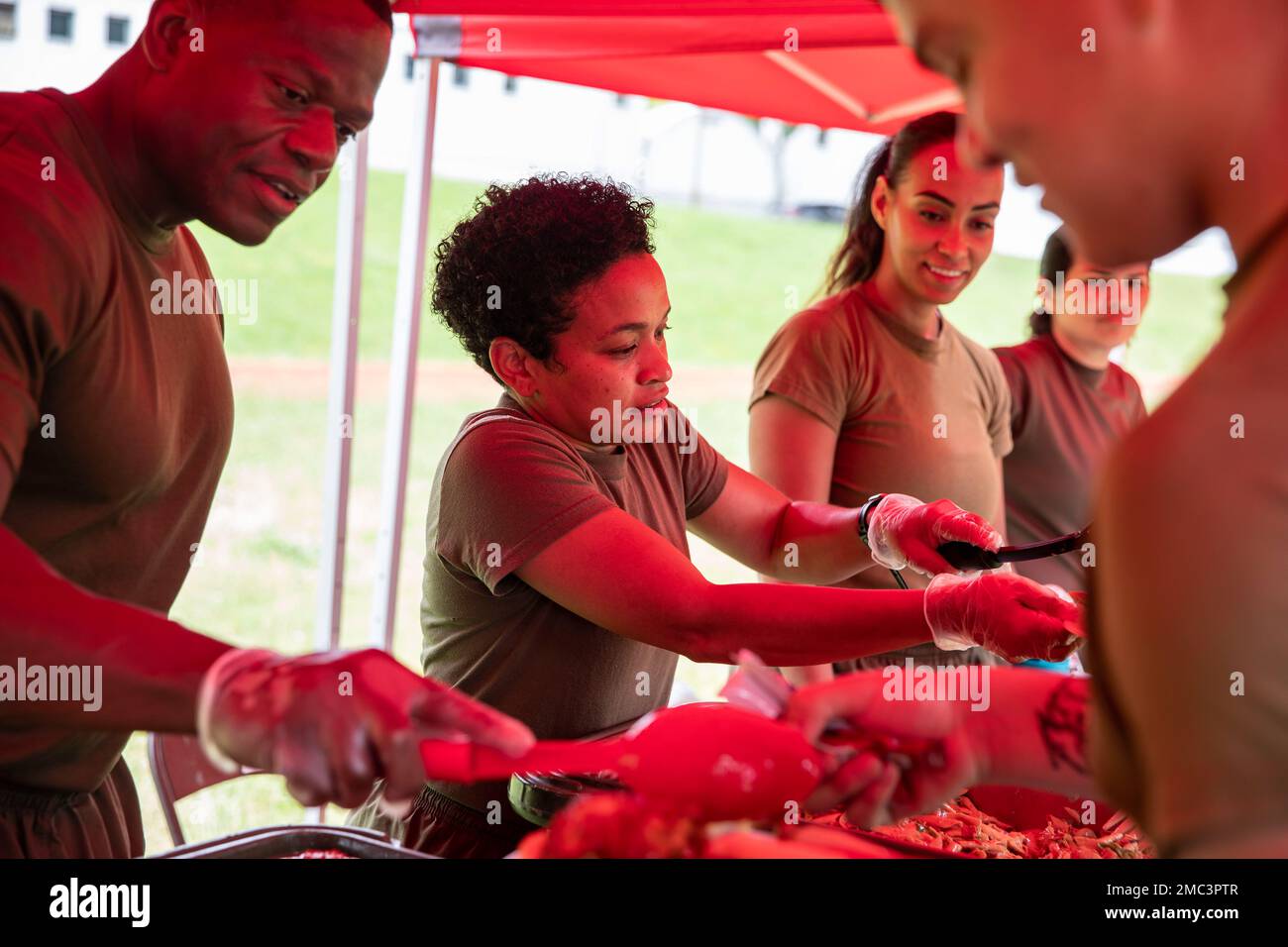 U.S. Marines with Security Battalion share a meal after participating ...