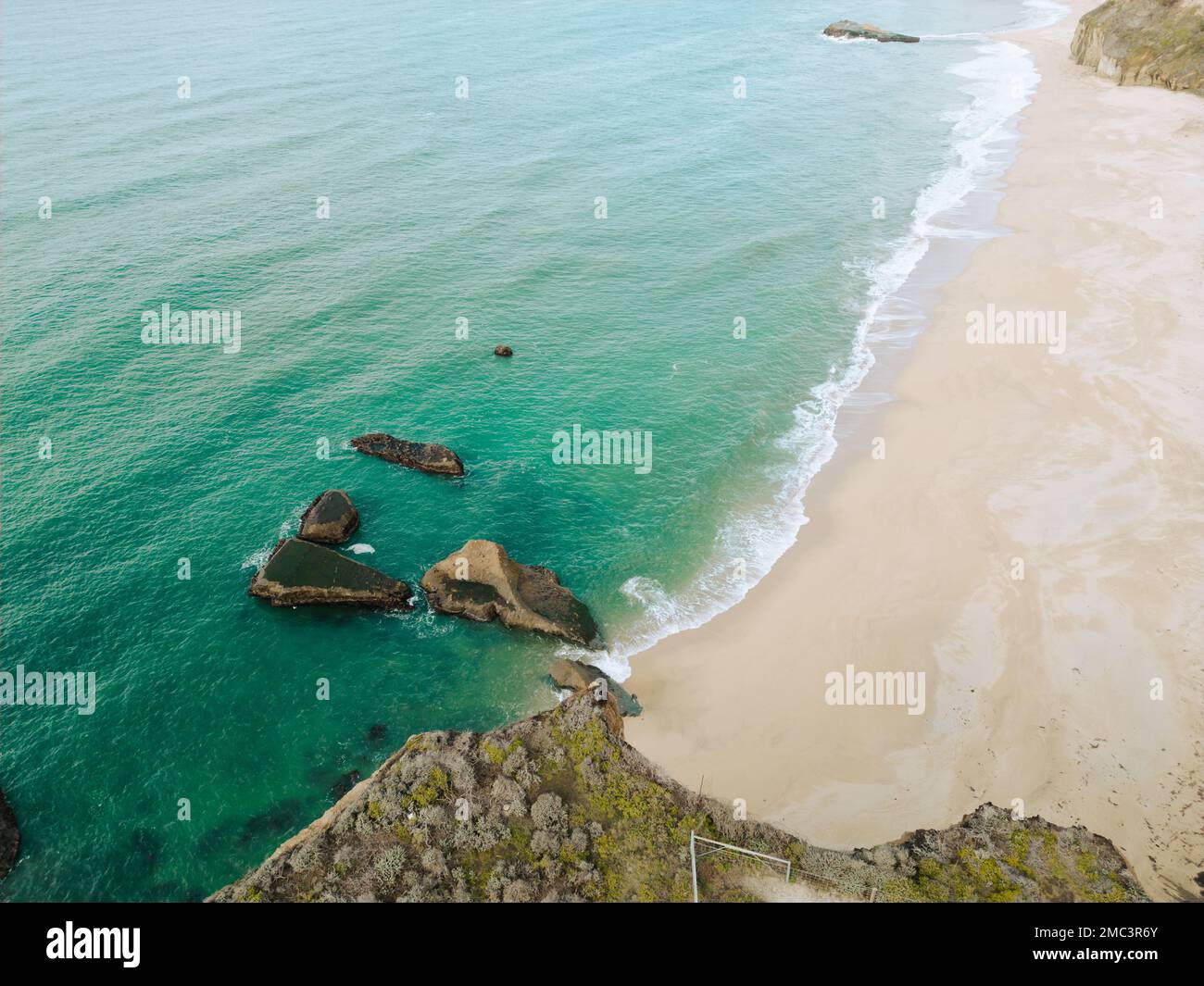 A drone shot of the foamy waves crashing the sandy shore, cool for ...