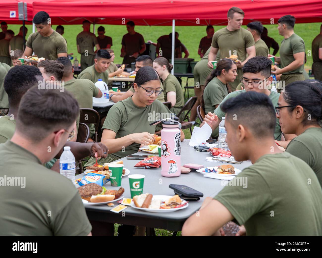 U.S. Marines with Security Battalion share a meal after participating ...