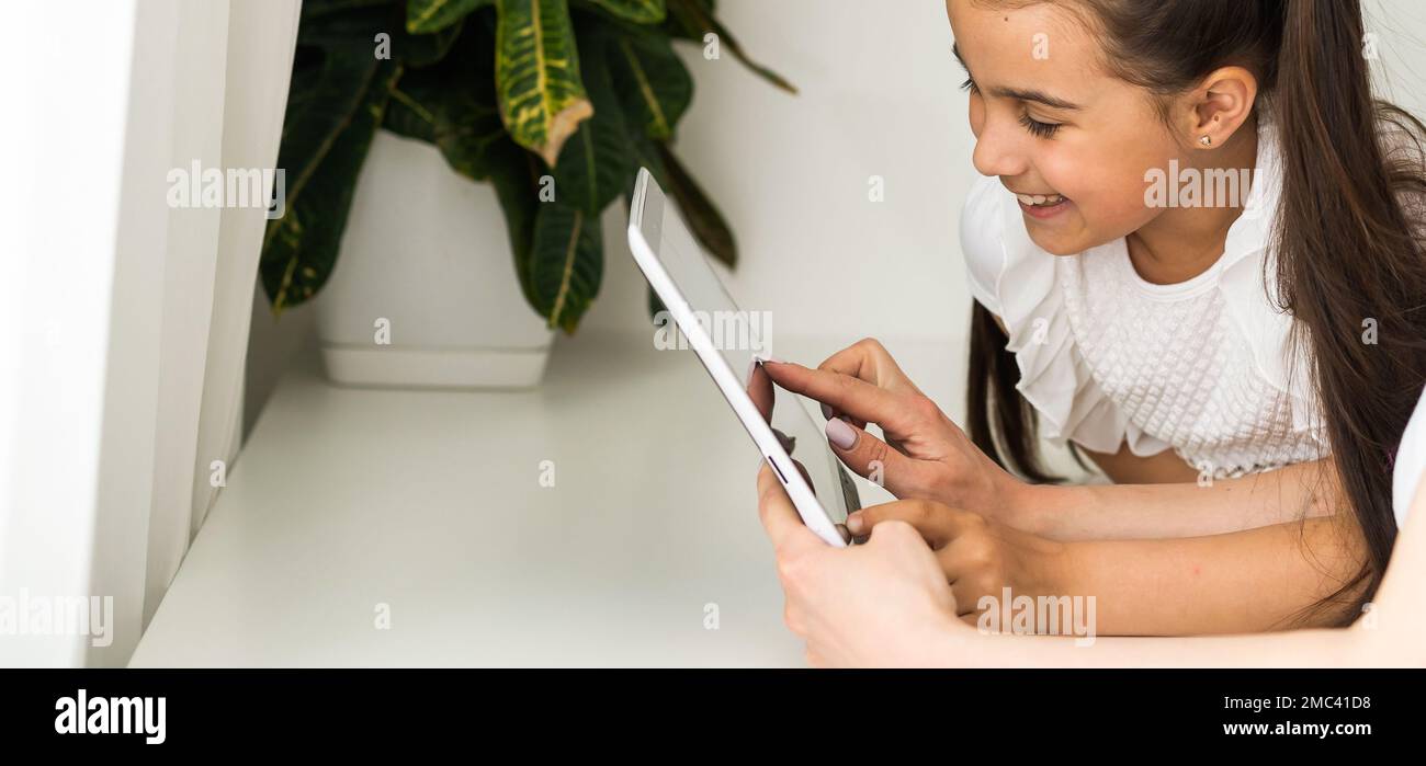 Online education of children. Mother and daughter of preschool watching ...