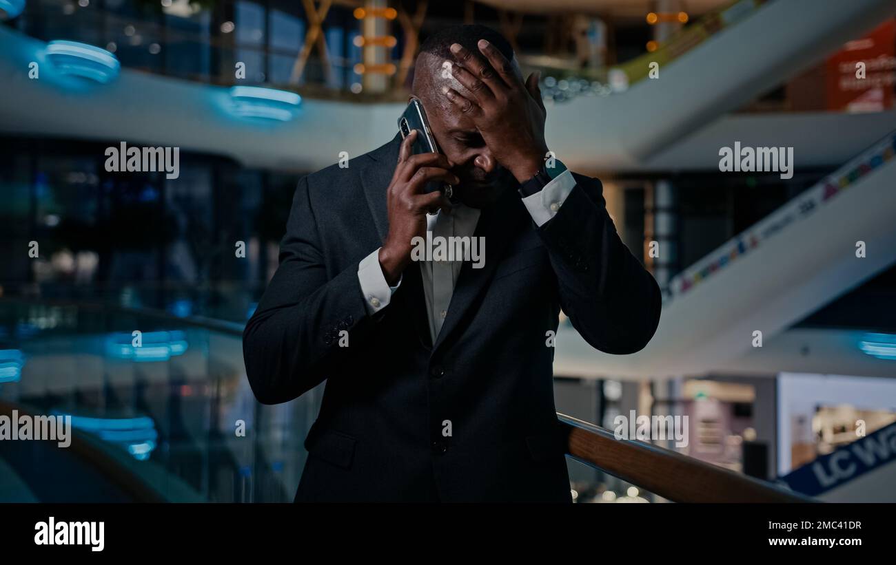 Ethnic middle-aged man African American entrepreneur answer phone call ...