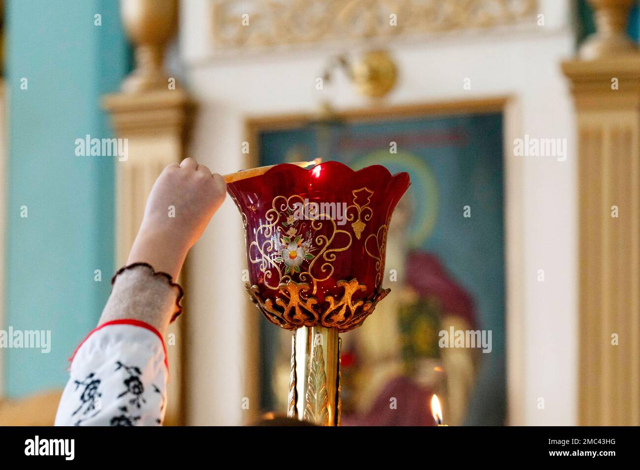 A candle is lit during the Mass at St. Andrew Ukrainian Orthodox ...