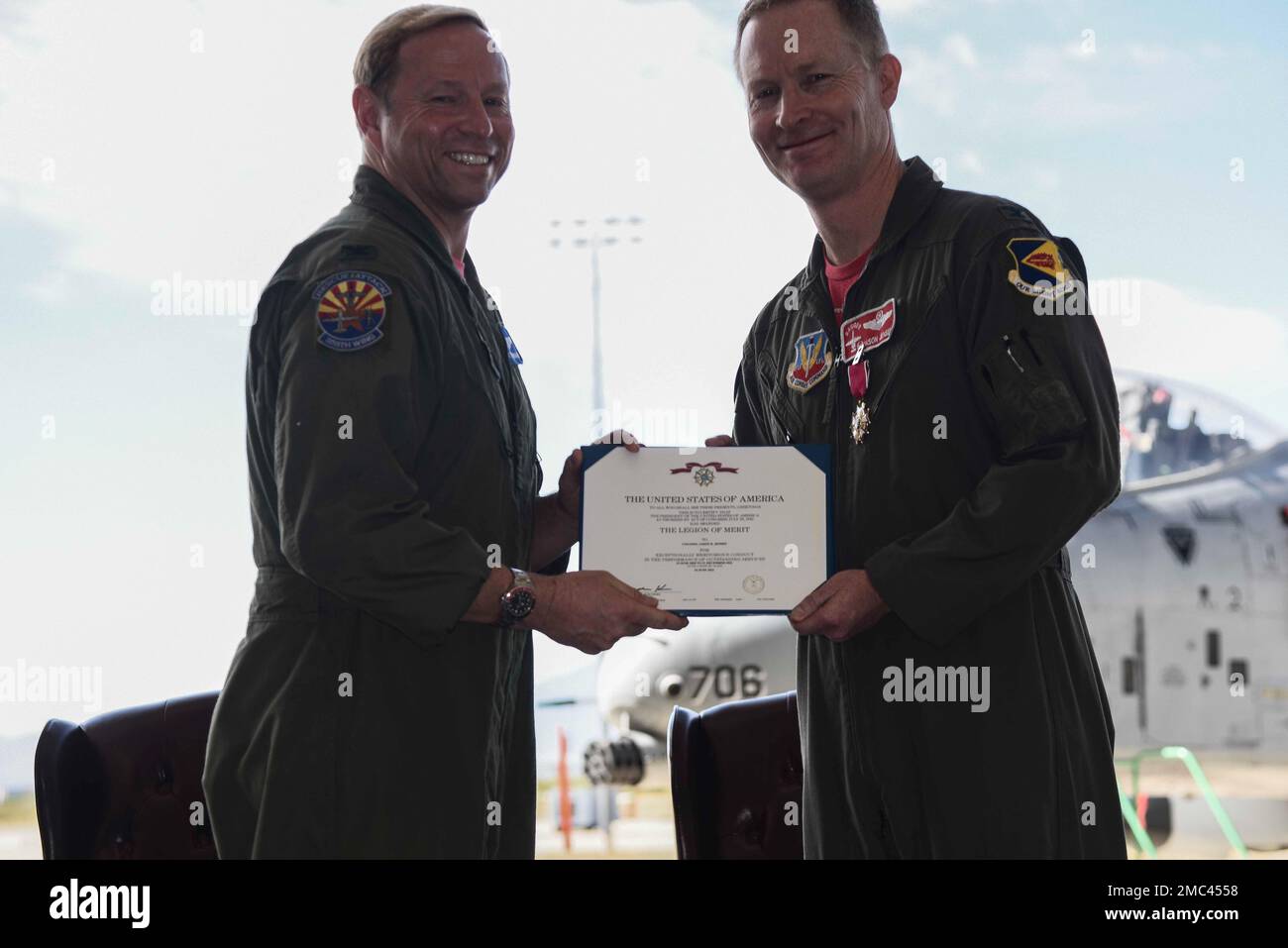 U.S. Air Force Col. Joseph Turnham presents Col. Jason Jensen with an ...