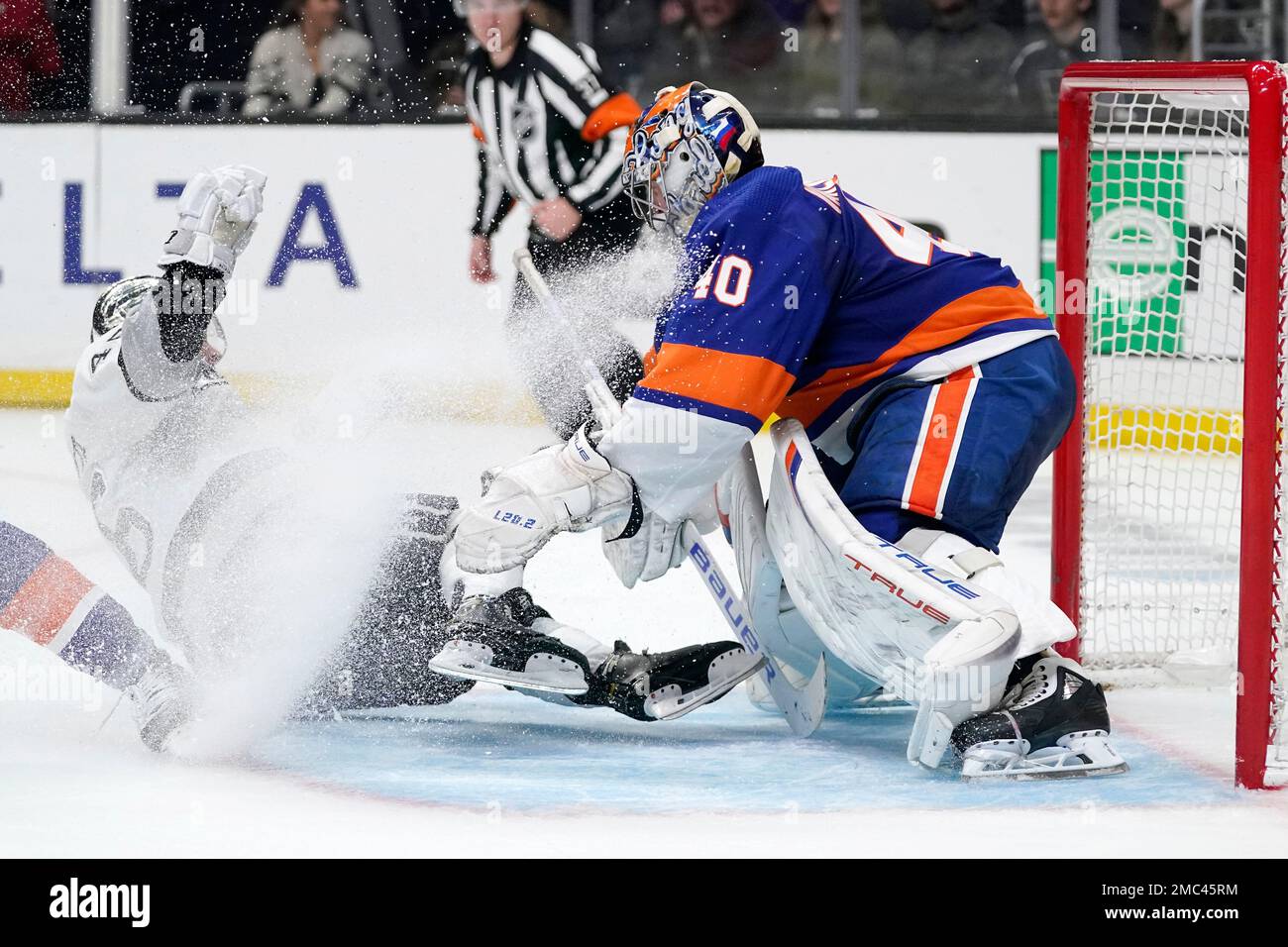 Los Angeles Kings center Blake Lizotte, left, slides into New York ...