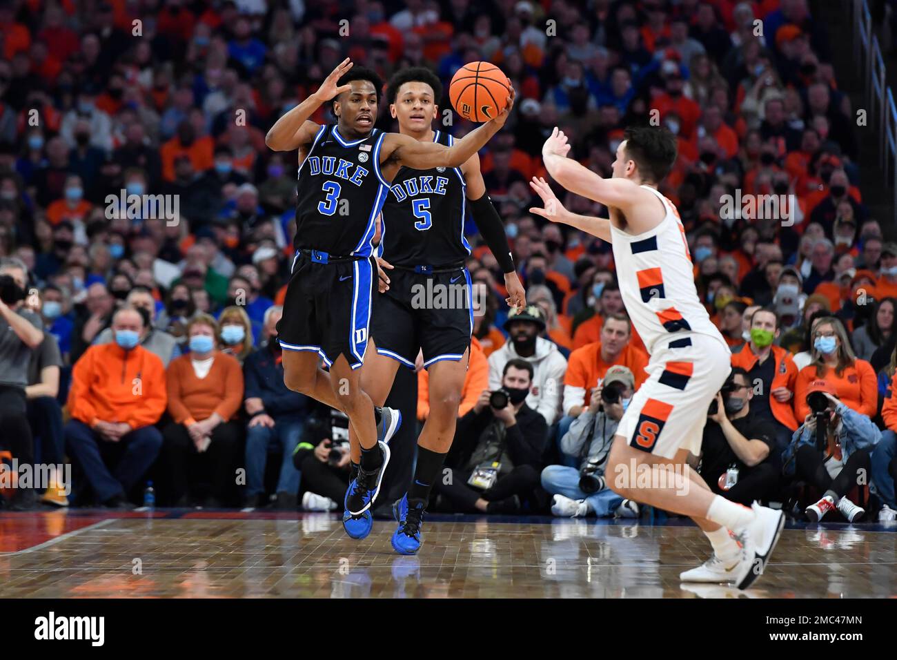 Duke guard Jeremy Roach, left, reaches for the ball next to Syracuse ...
