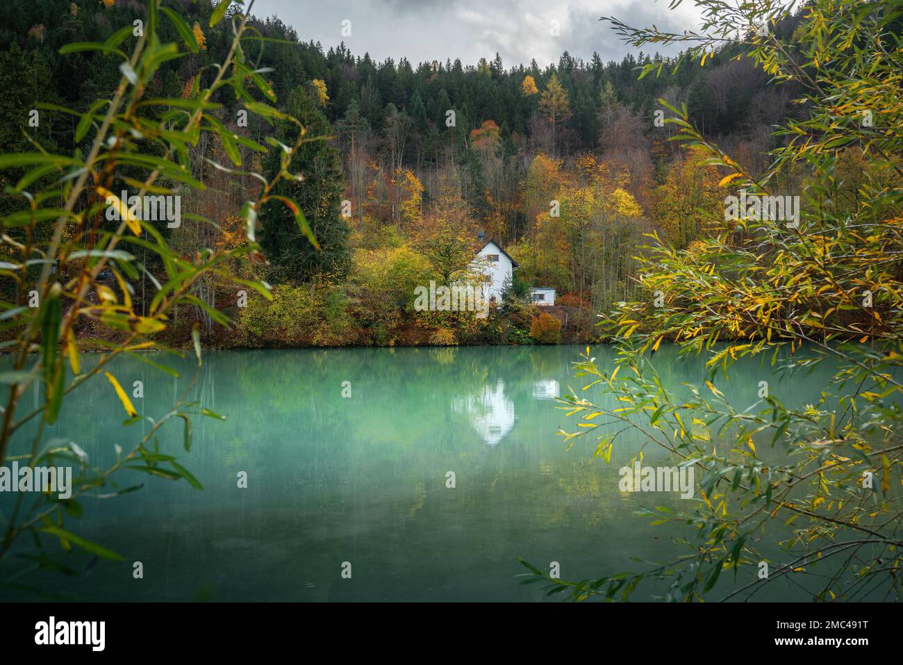 House and vegetation at turquoise Lech River - Fussen, Bavaria, Germany ...