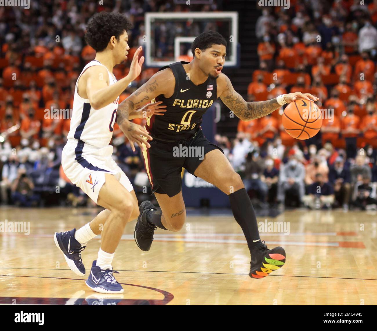 Florida State guard RayQuan Evans, right, moves past Virginia guard ...