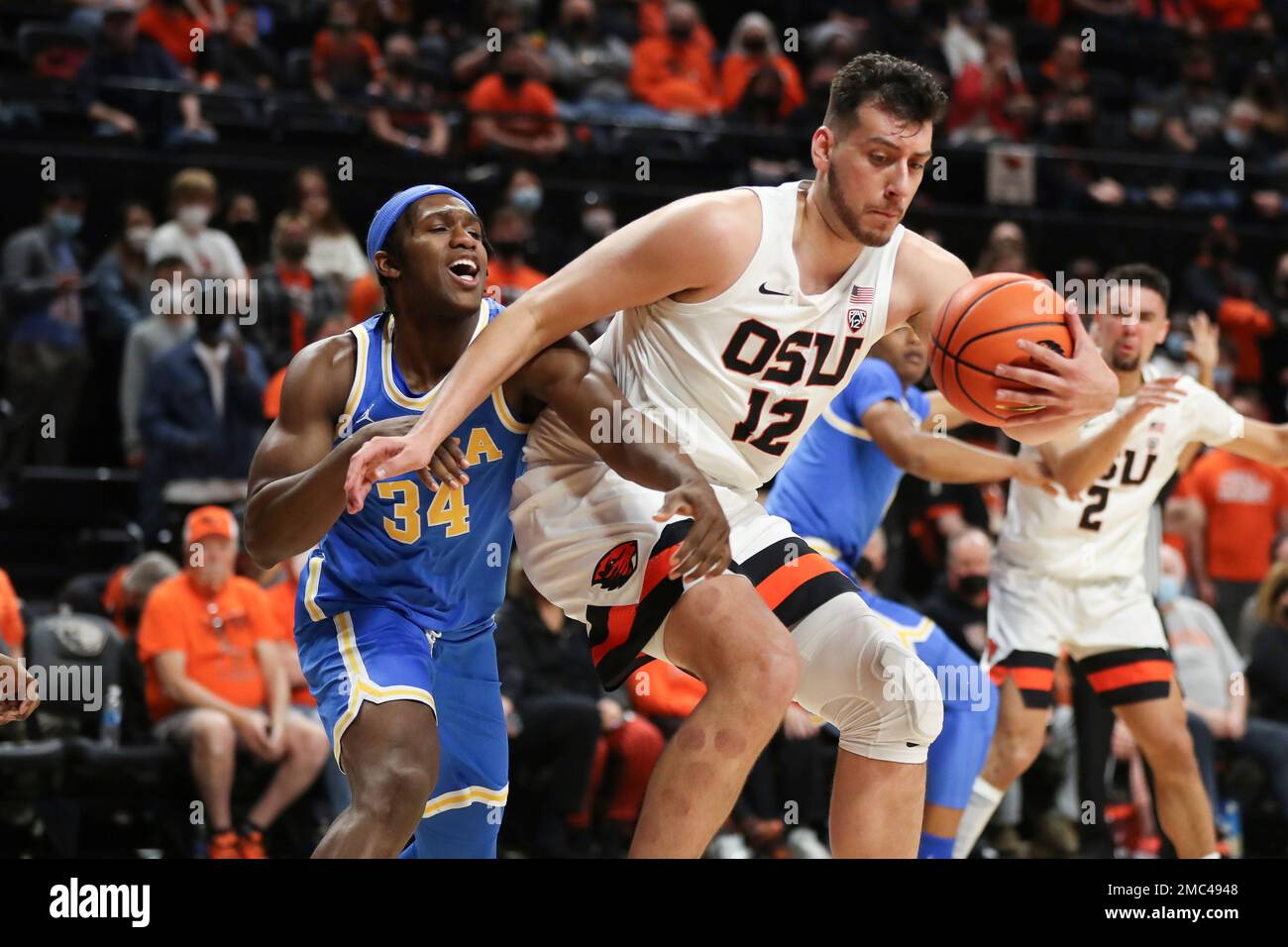 Oregon State center Roman Silva, front right, dodges UCLA guard David ...