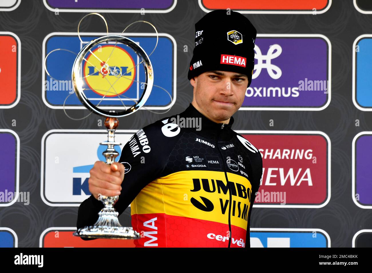 First place, Belgium's Wout Van Aert of Jumbo Visma, holds his trophy ...