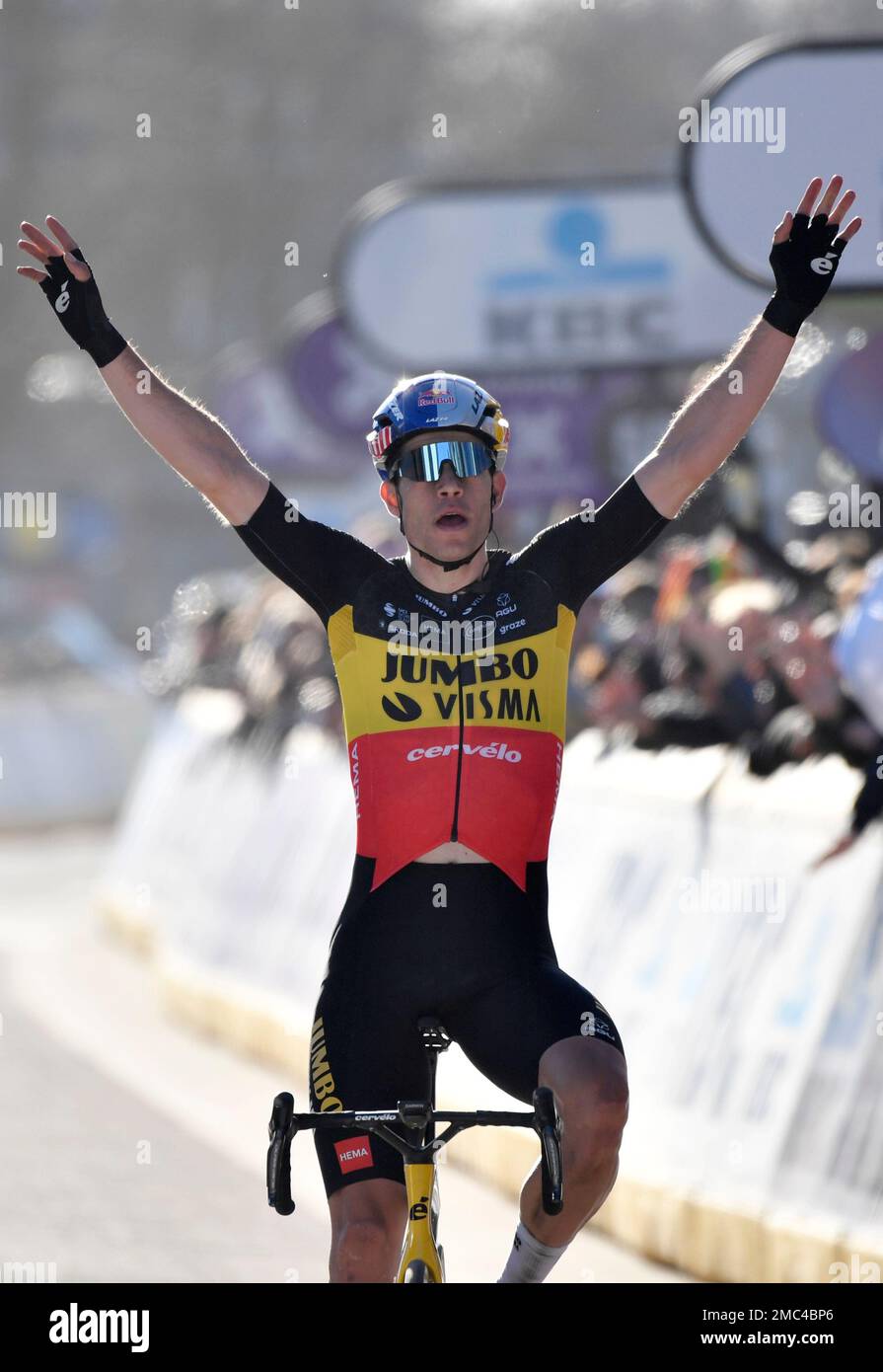 Belgium's Wout Van Aert of the Jumbo Visma team crosses the finish line ...