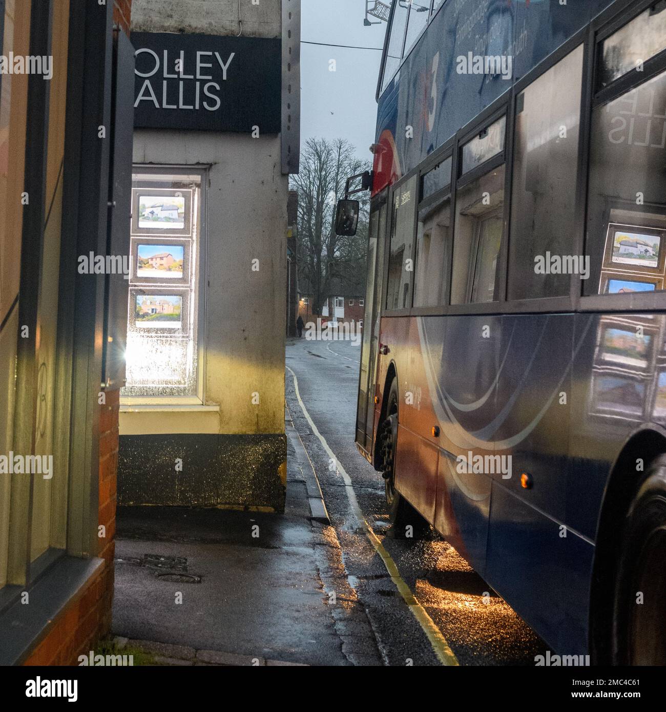 Bus in a narrow street with narrow pavement Stock Photo - Alamy