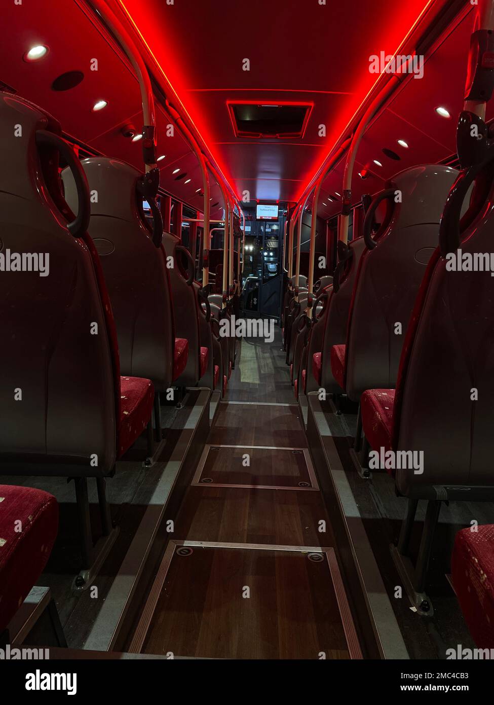 The interior of a bus illuminated with red light Stock Photo - Alamy