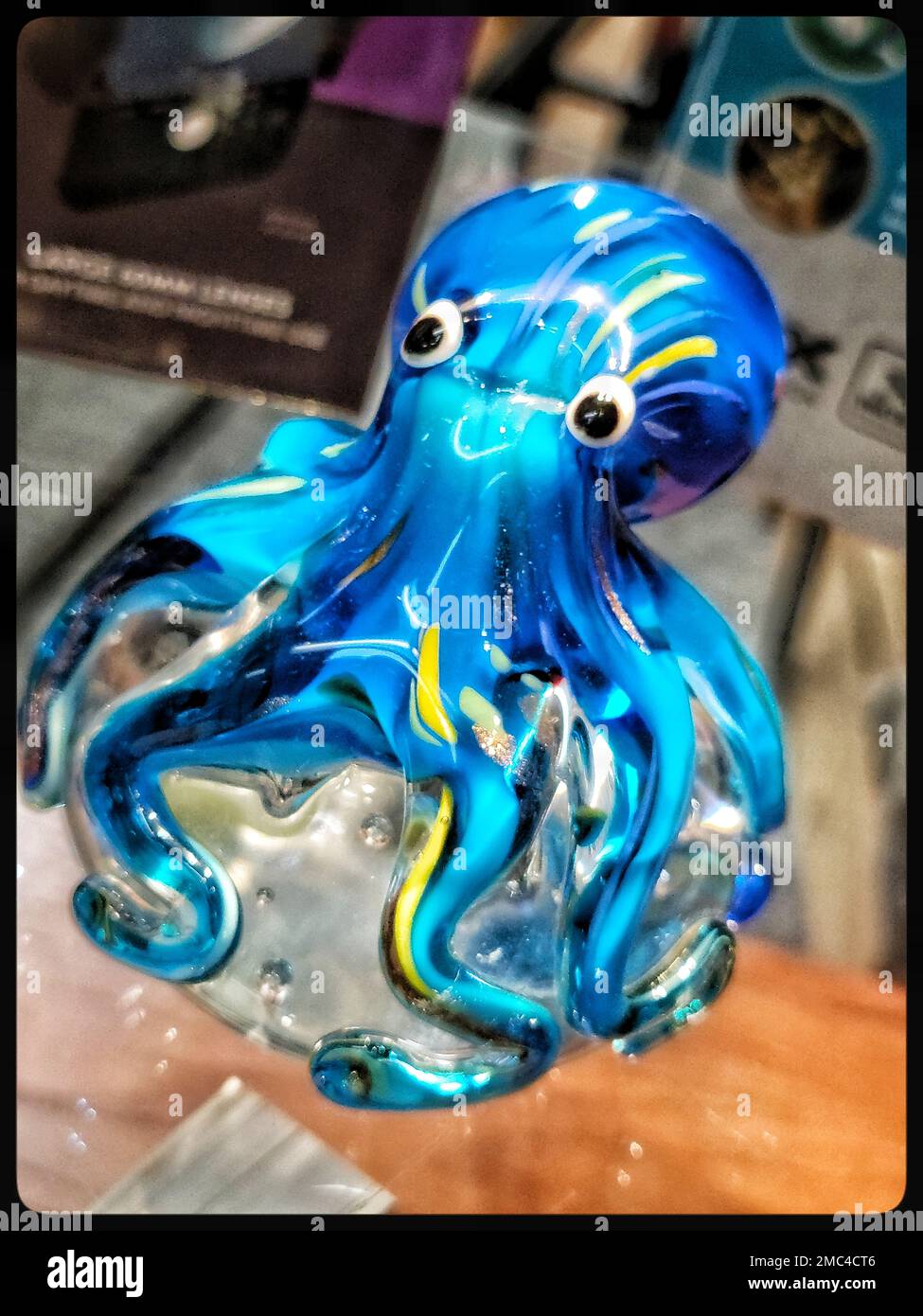 A vertical closeup of a blue glass octopus with googly eyes Stock Photo ...