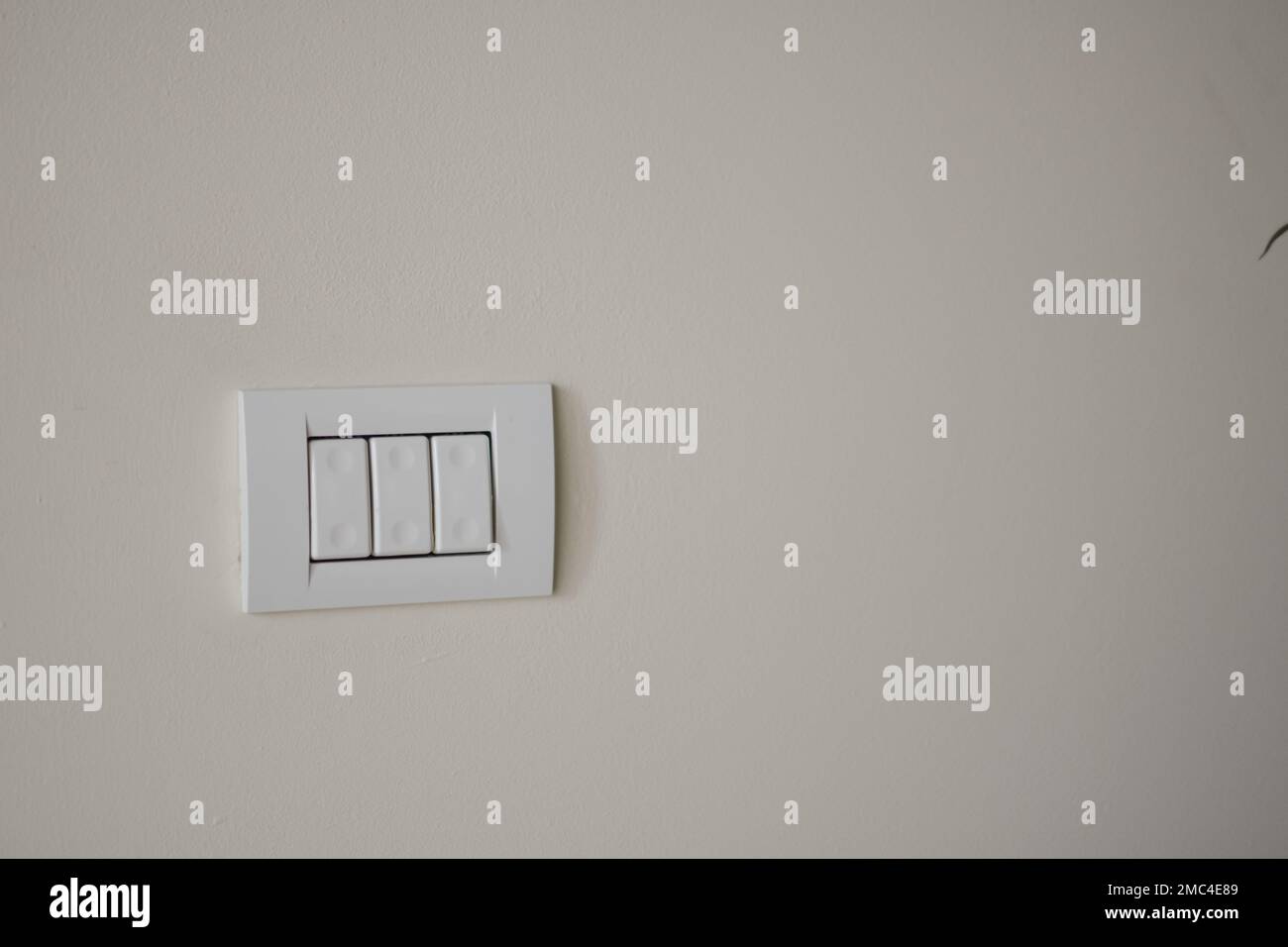 Contemporary modern electric light switches on on a light living room ...