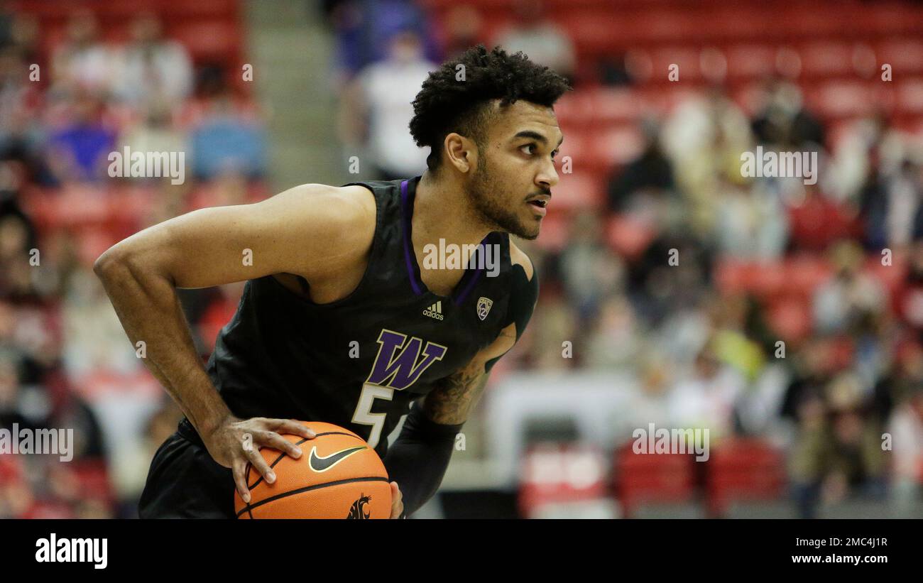 Washington guard Jamal Bey controls the ball during the first half of ...