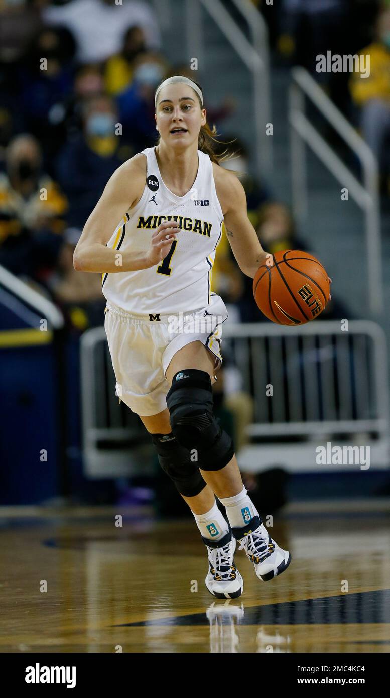 Michigan guard Amy Dilk (1) drives the ball up court against Michigan ...