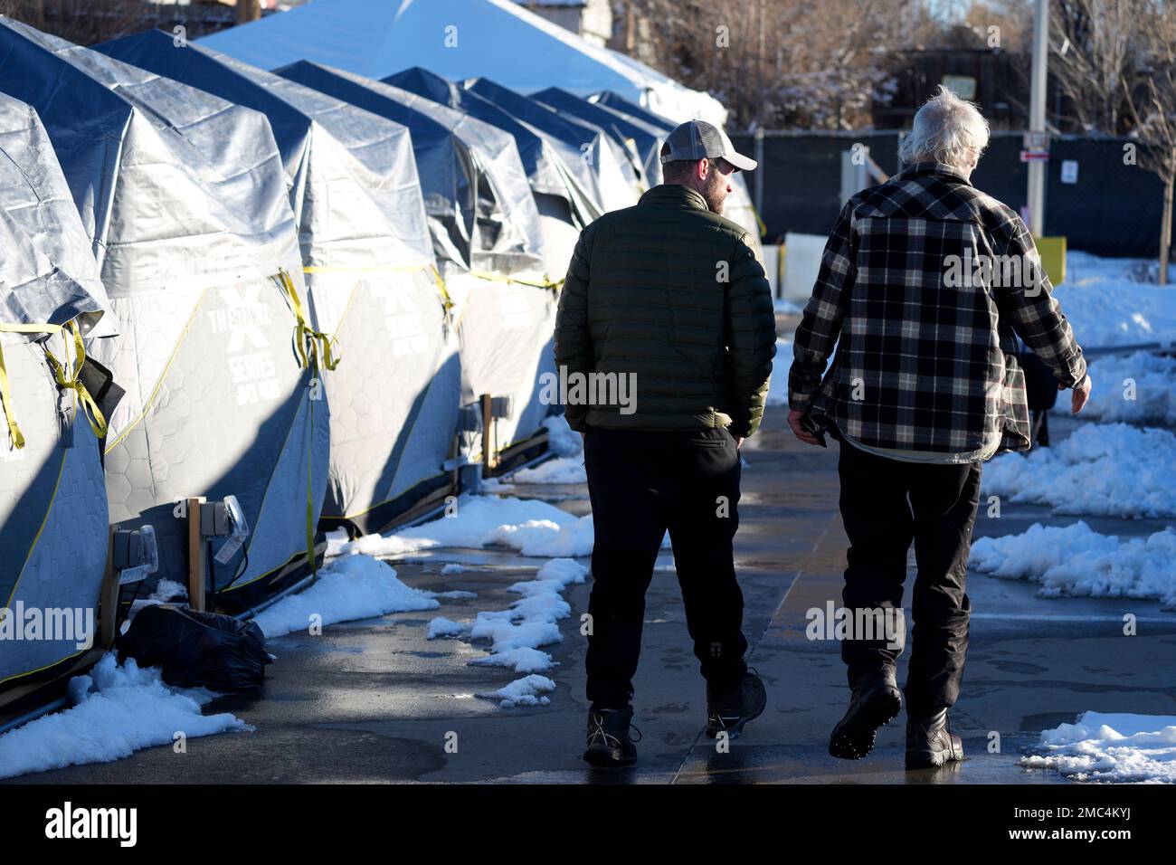 Tents stand in a long row at the east safe outdoor space in the parking ...