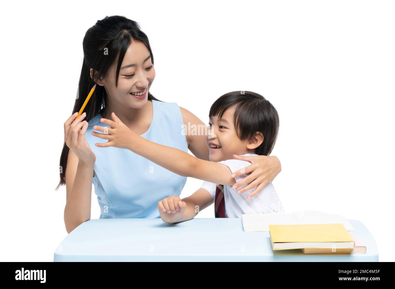 A young female teacher counseling boy learning Stock Photo - Alamy