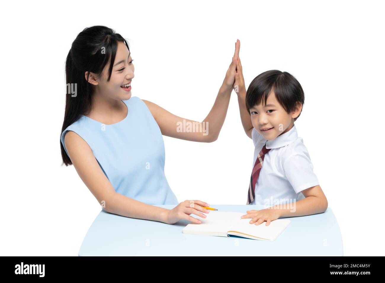 A young female teacher counseling boy learning Stock Photo - Alamy