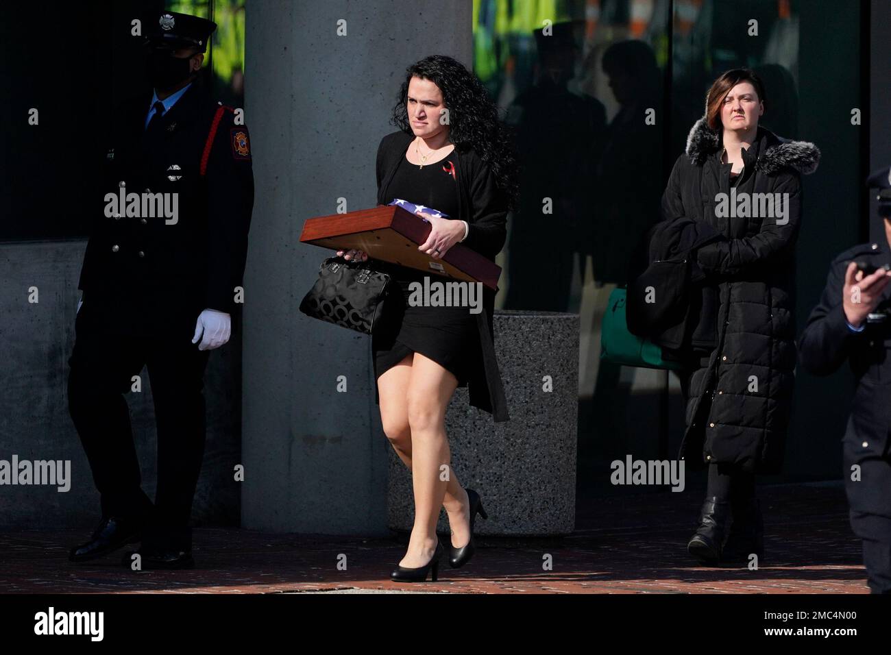 Rachel Butrim, widow of Baltimore City Fire Lt. Paul Butrim, holds a ...