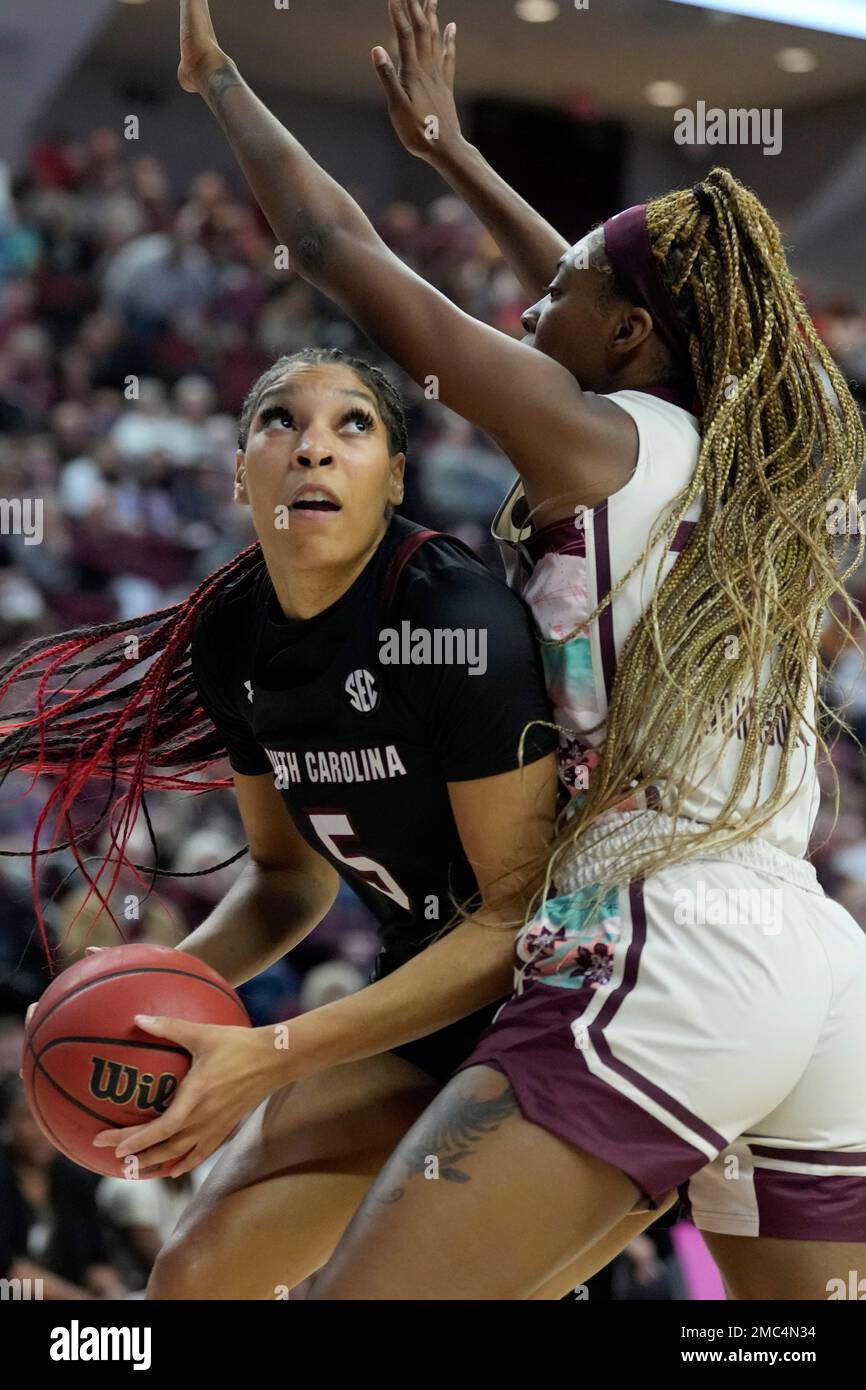 South Carolina forward Victaria Saxton (5), left, looks to shoot past ...