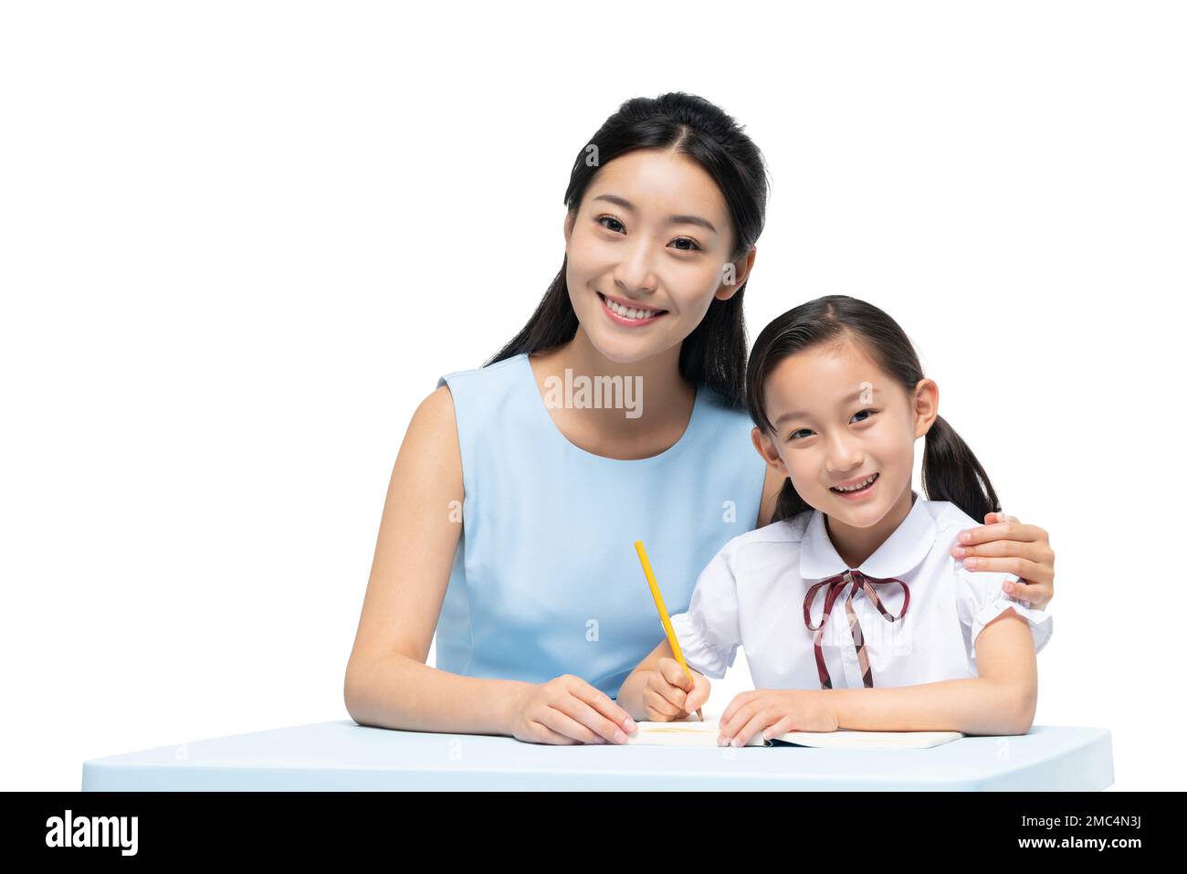 A young female teacher counseling students learning Stock Photo - Alamy
