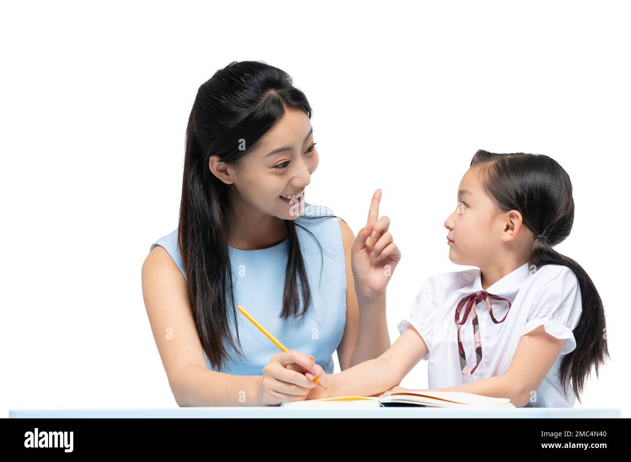 A young female teacher counseling students learning Stock Photo - Alamy