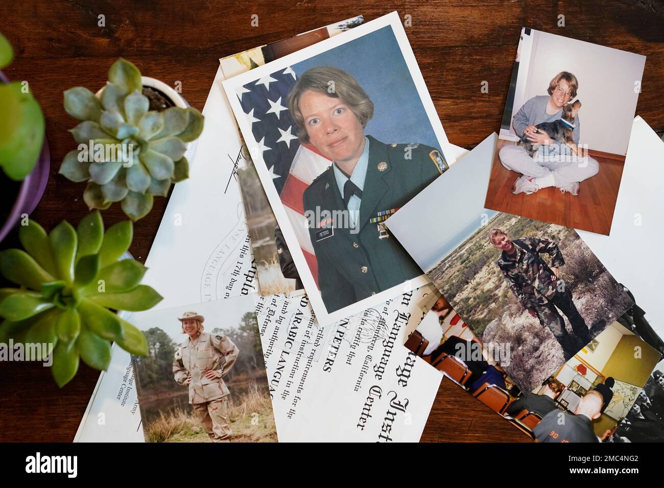 Photos of Julie Akey during her time at Fort Ord rest on a table in her ...