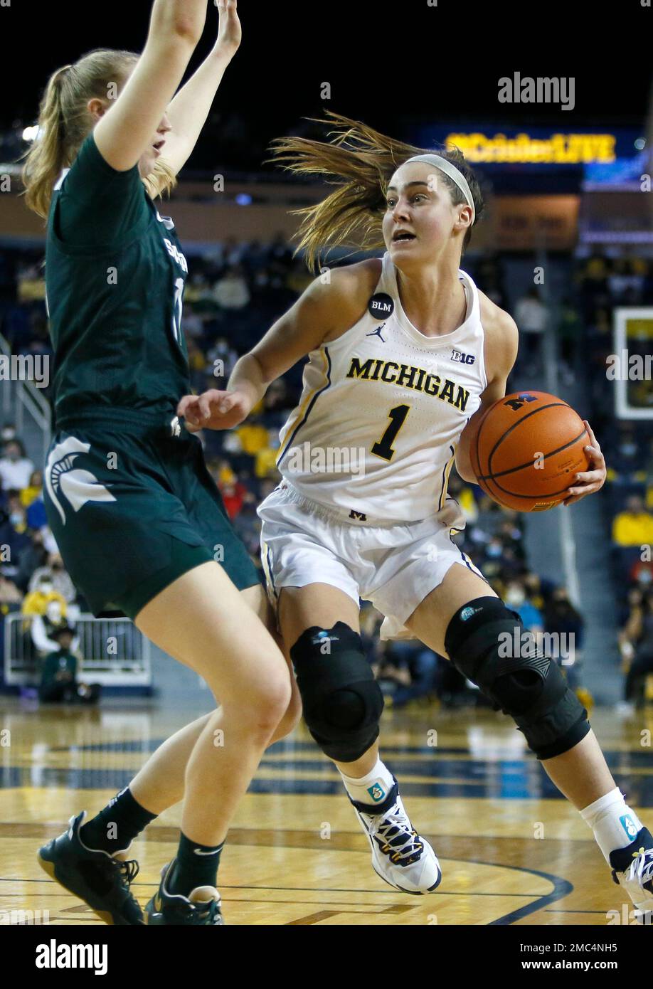 Michigan guard Amy Dilk (1) drives against Michigan State guard Matilda ...