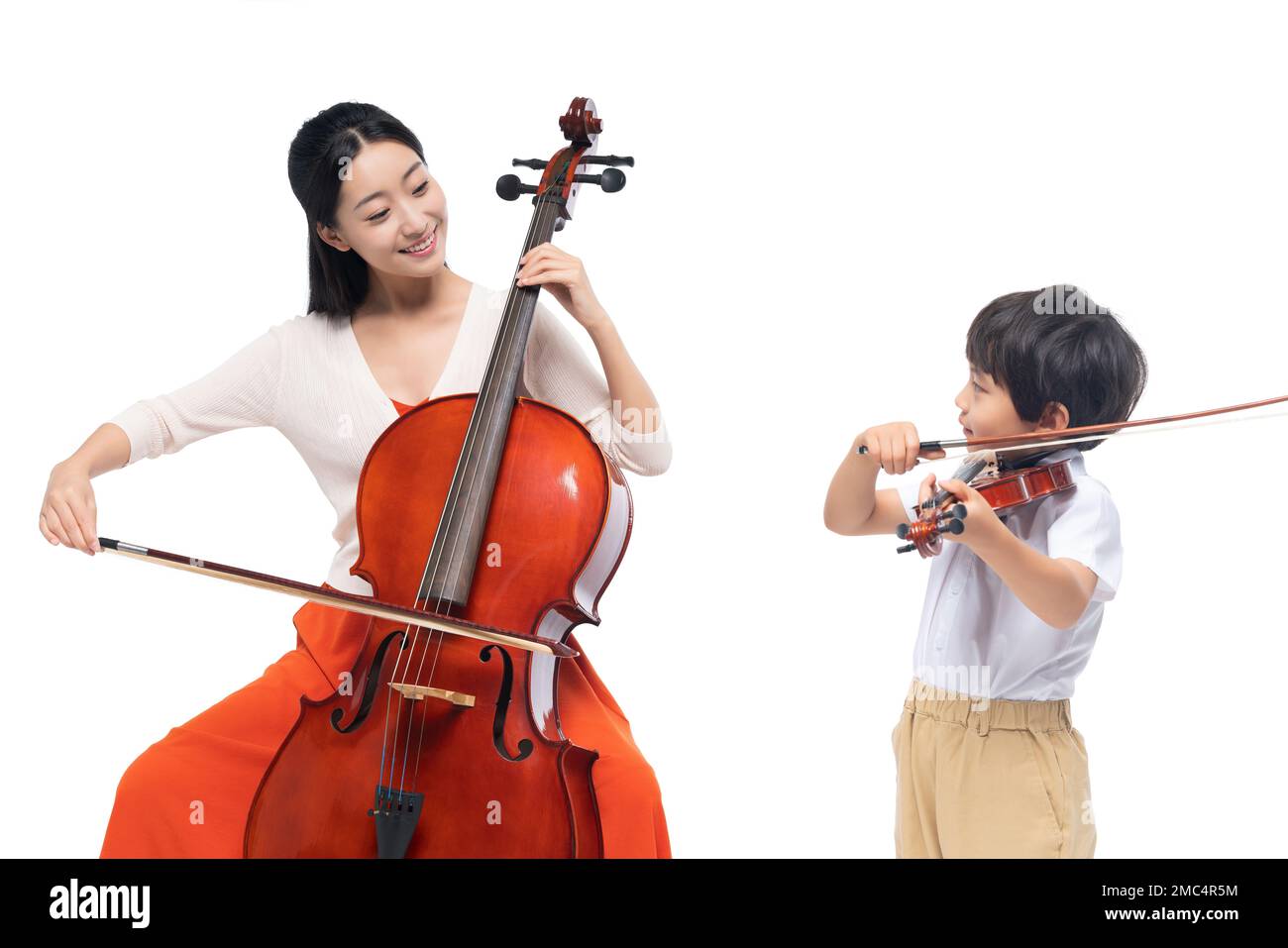 The female teacher guide the boy playing Musical Instruments Stock ...