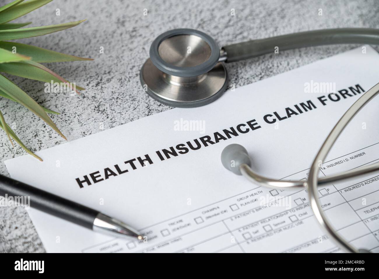 Top view of doctor stethoscope, pen and health insurance claim form on ...