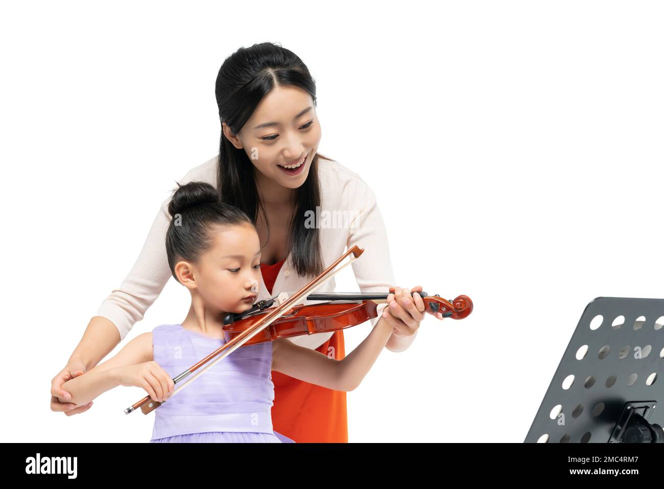 The female teacher guide girl playing Musical Instruments Stock Photo ...