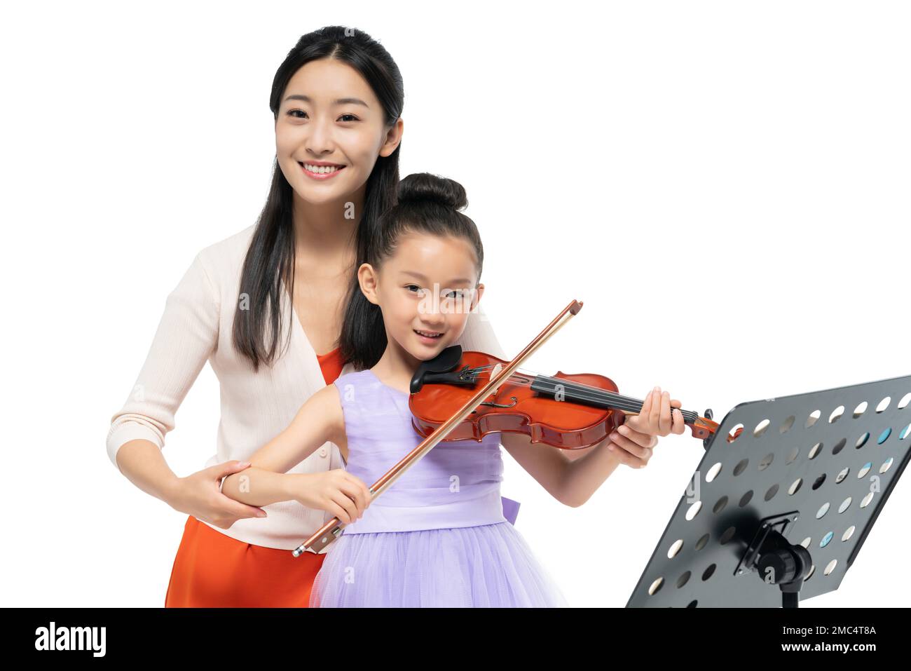 The female teacher guide girl playing Musical Instruments Stock Photo ...