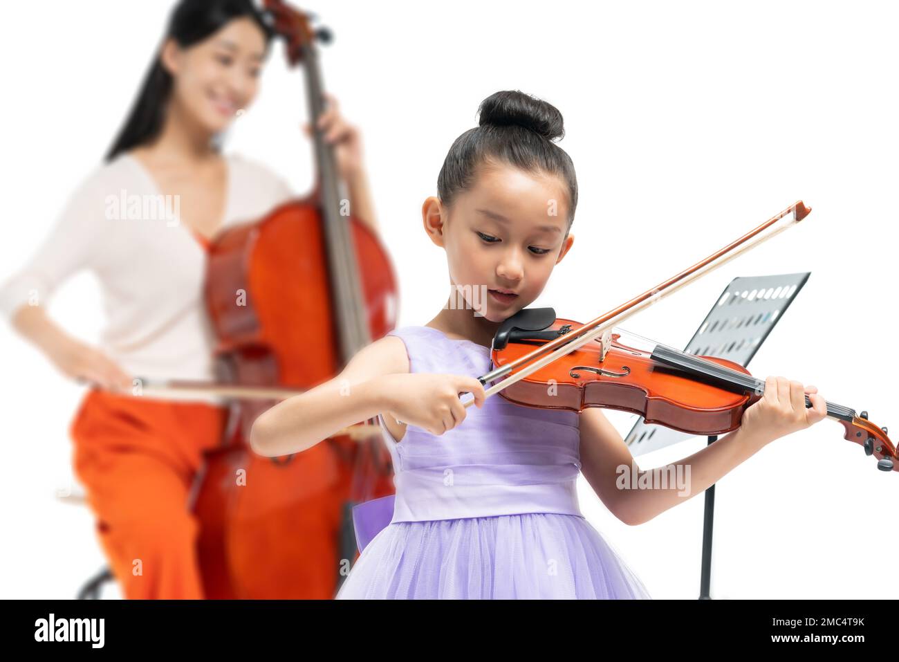 The female teacher guide girl playing Musical Instruments Stock Photo ...