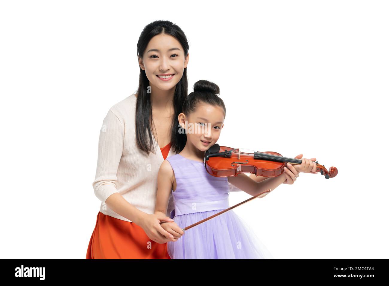 The female teacher guide girl playing Musical Instruments Stock Photo ...