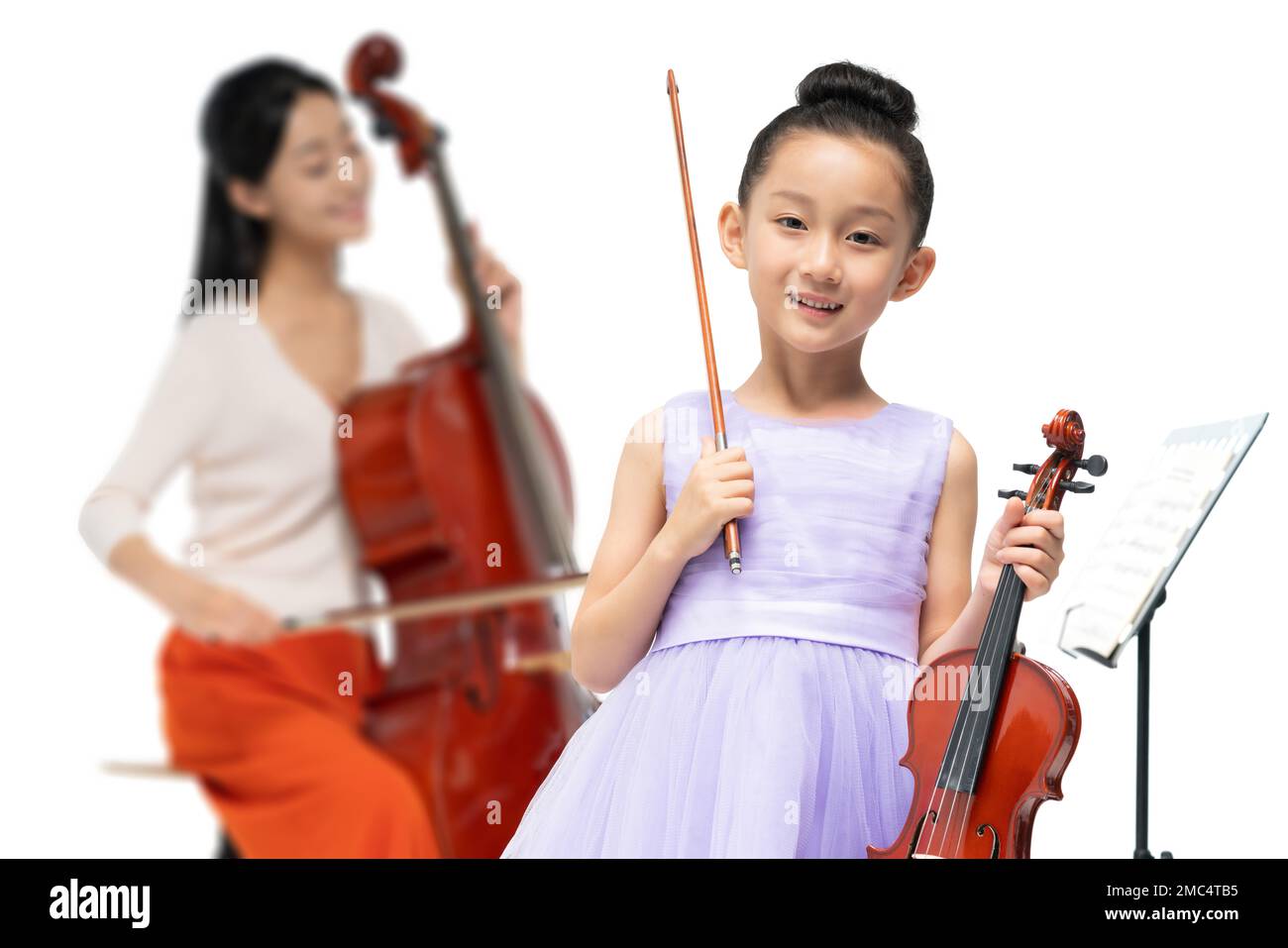 The female teacher guide girl playing Musical Instruments Stock Photo ...