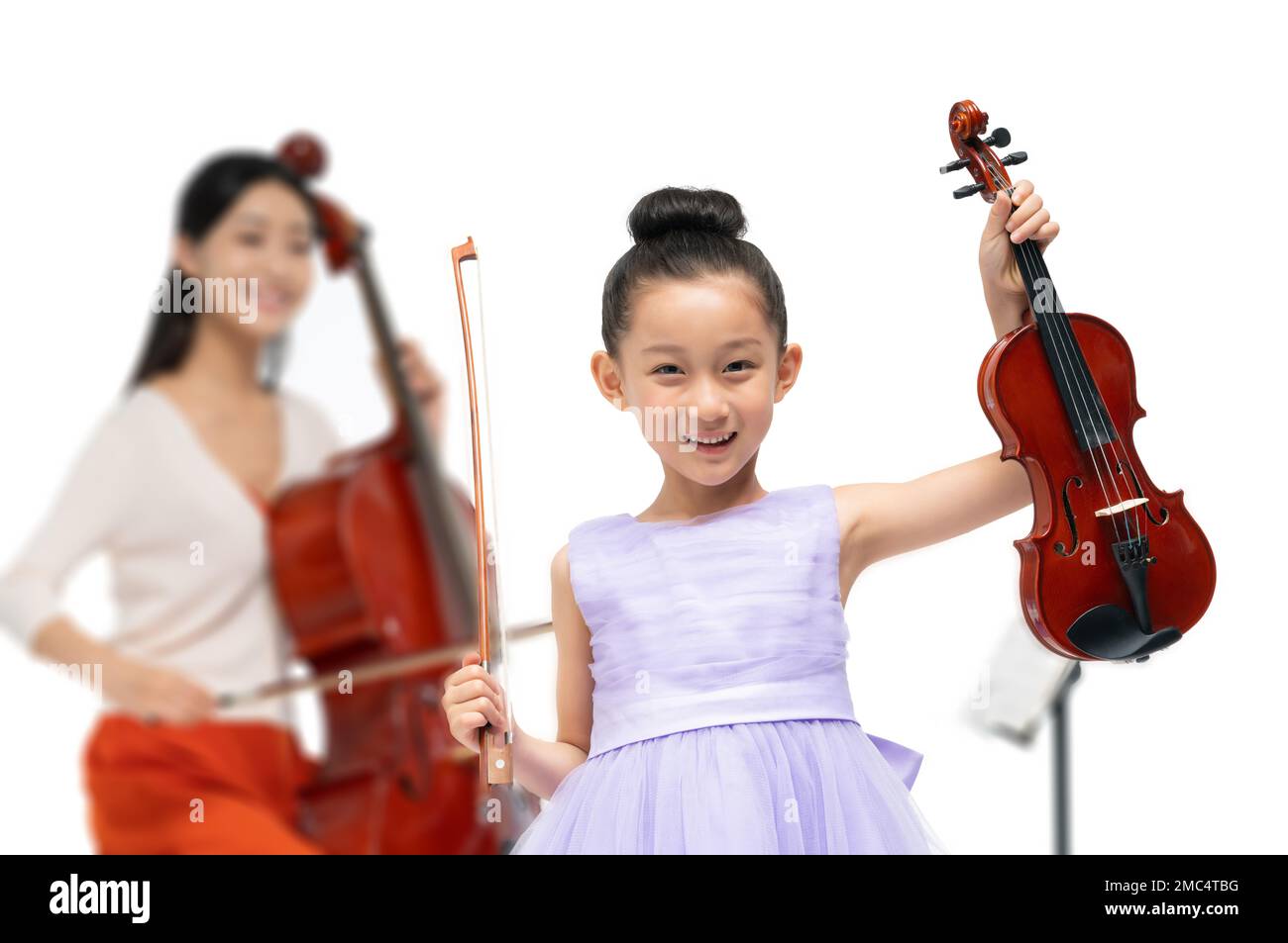 The female teacher guide girl playing Musical Instruments Stock Photo ...