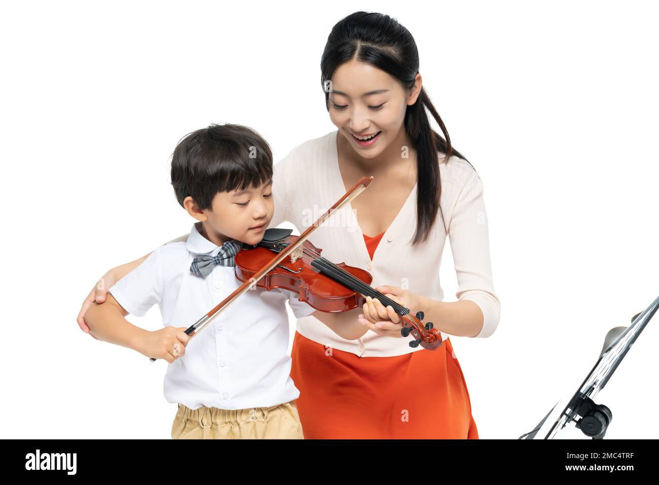 The female teacher guide the boy playing Musical Instruments Stock ...