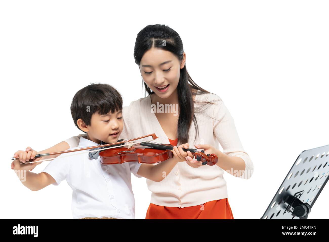 The female teacher guide the boy playing Musical Instruments Stock ...
