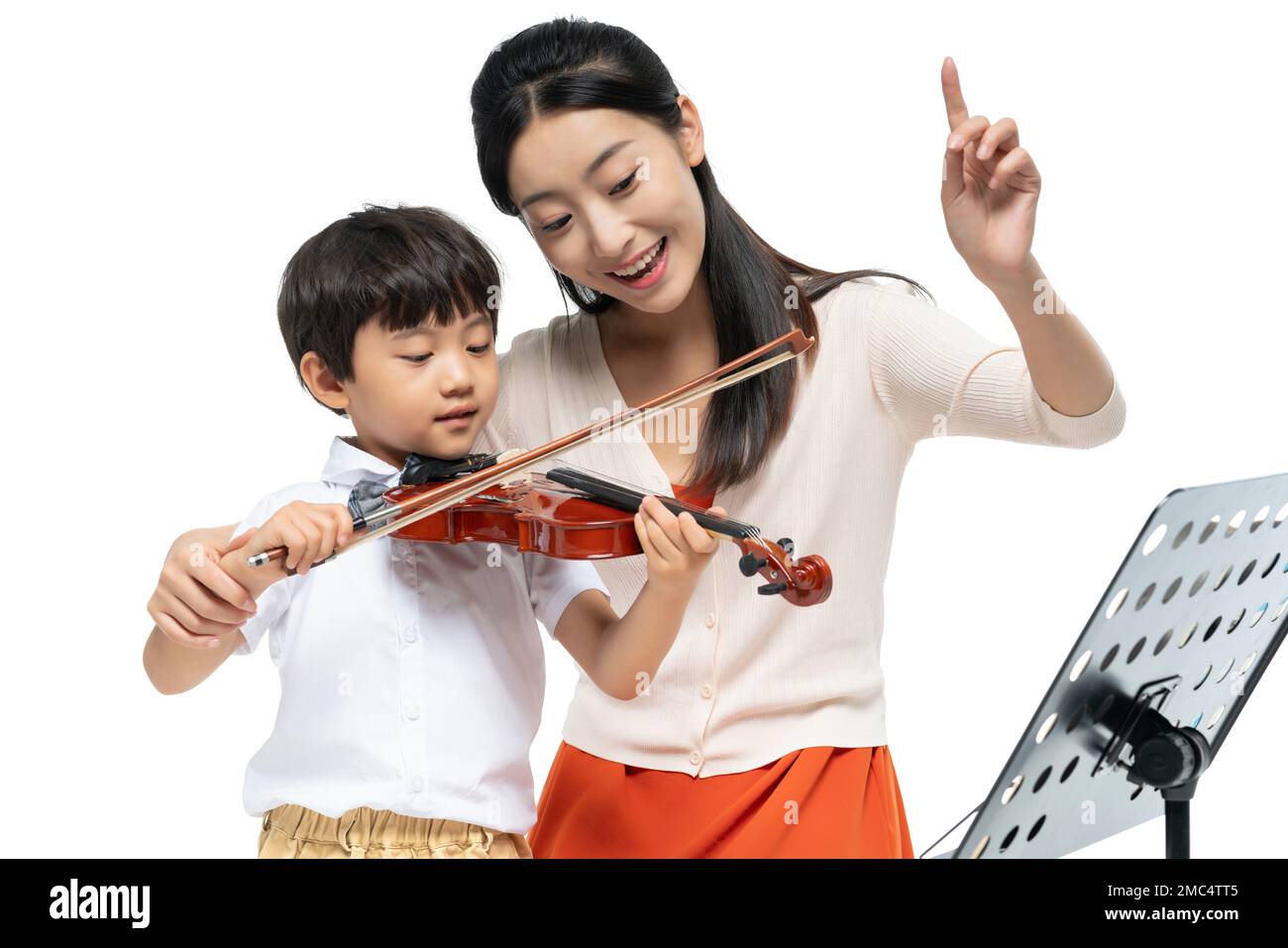 The female teacher guide the boy playing Musical Instruments Stock ...
