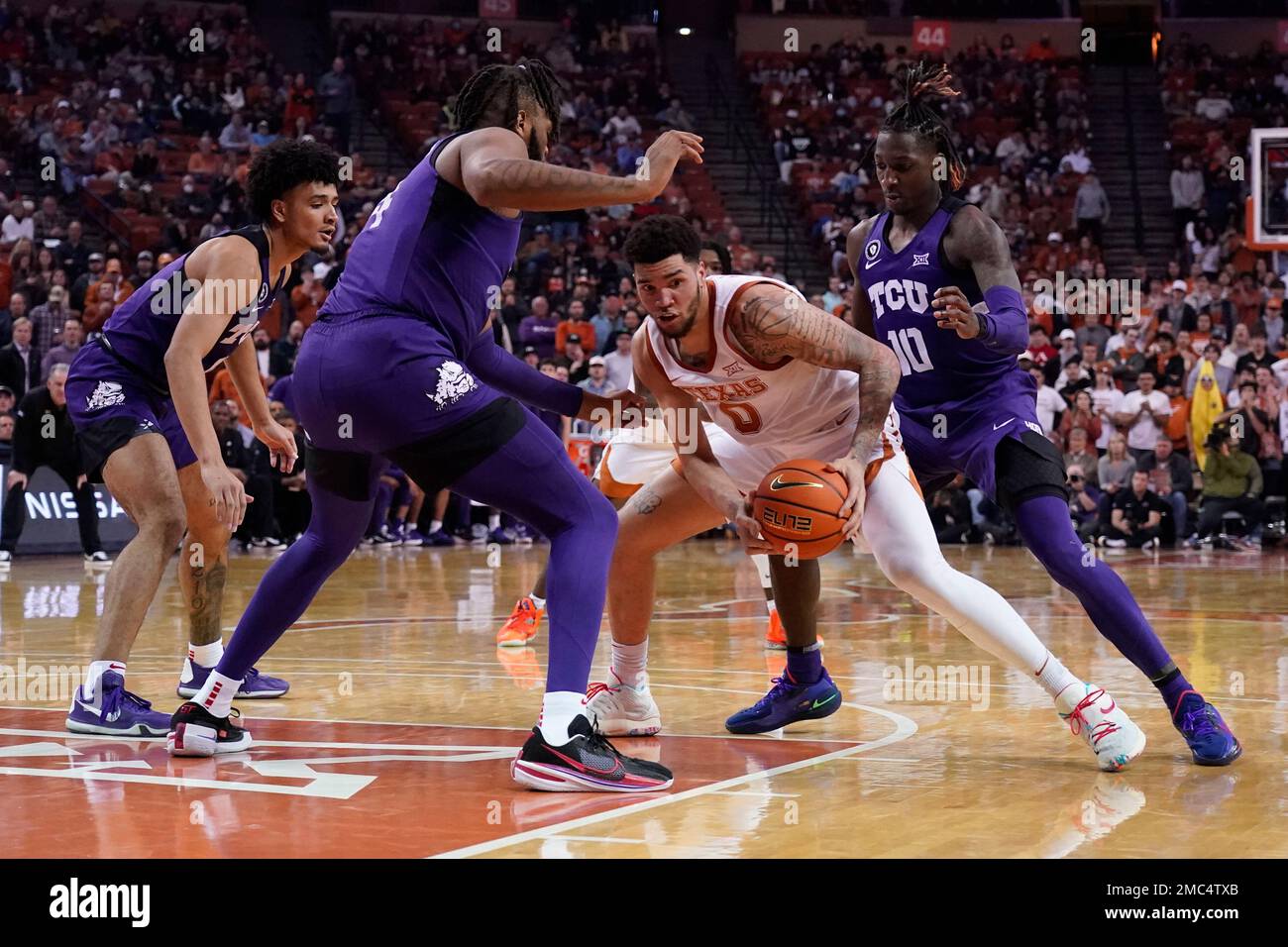 Texas forward Timmy Allen (0) is trapped by TCU guard Damion Baugh (10 ...