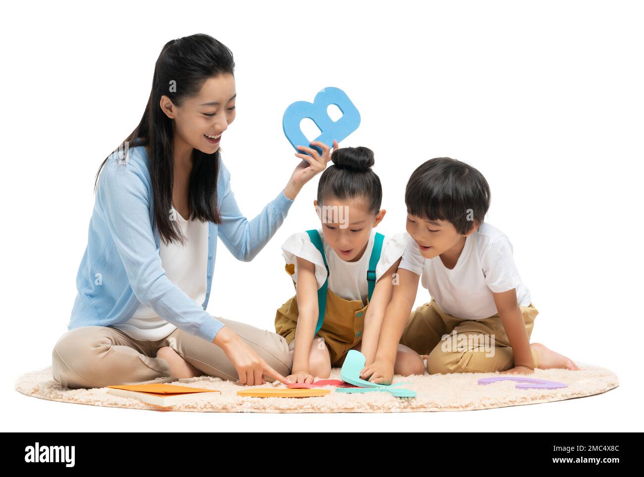 A young female teacher counseling students learning Stock Photo - Alamy