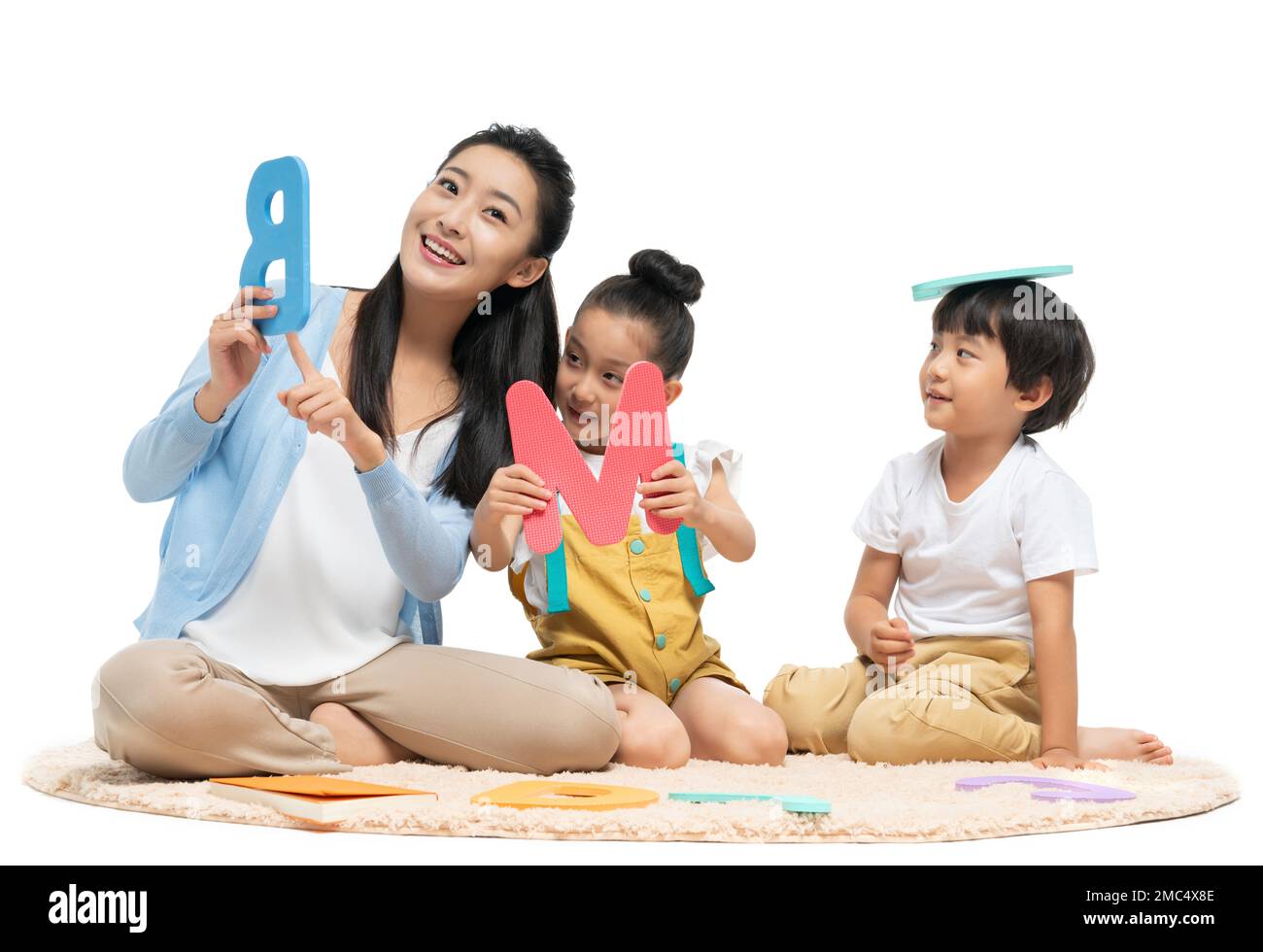 A young female teacher counseling students learning Stock Photo - Alamy