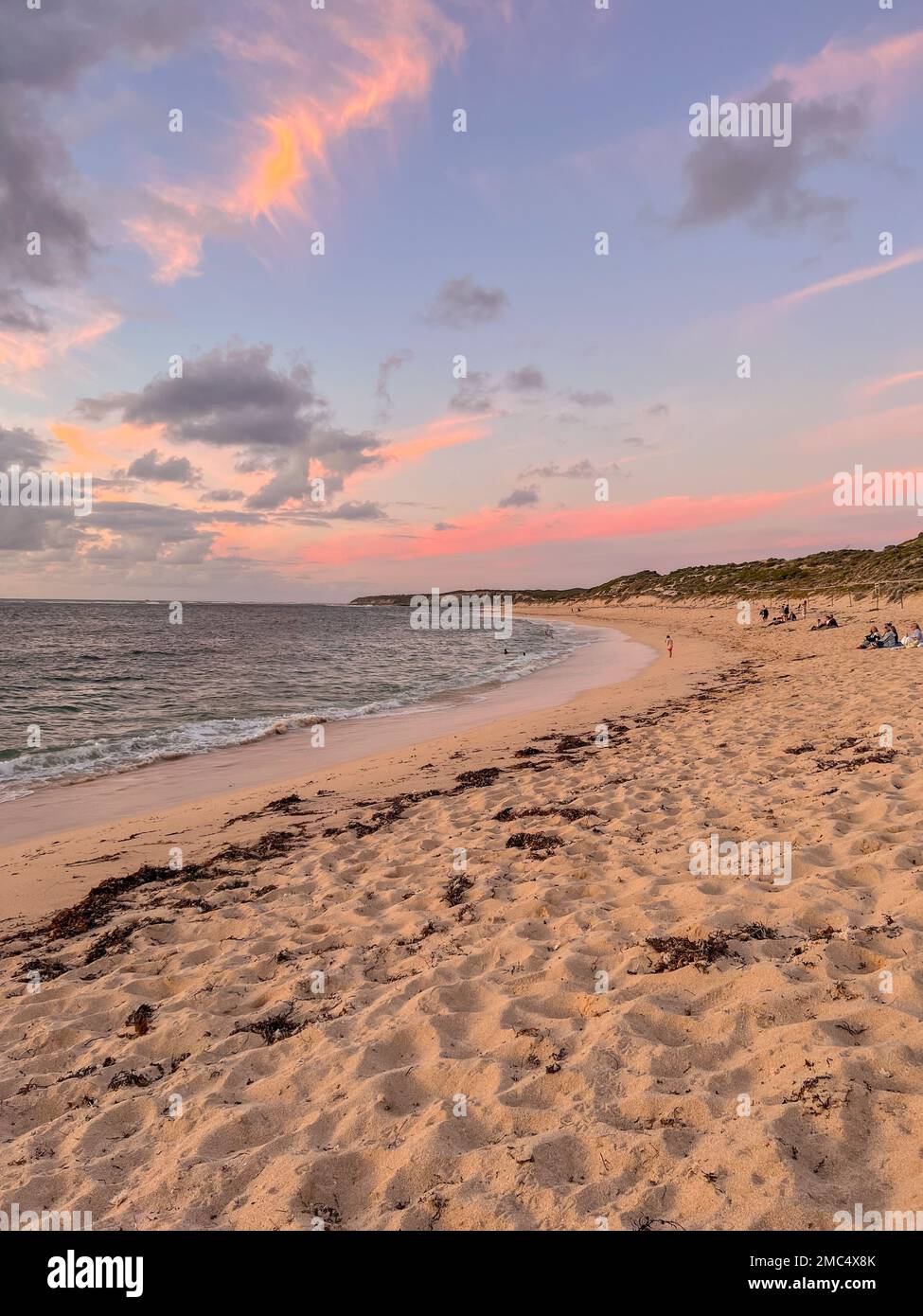 A sandy beach during the dramatic sunset Stock Photo - Alamy