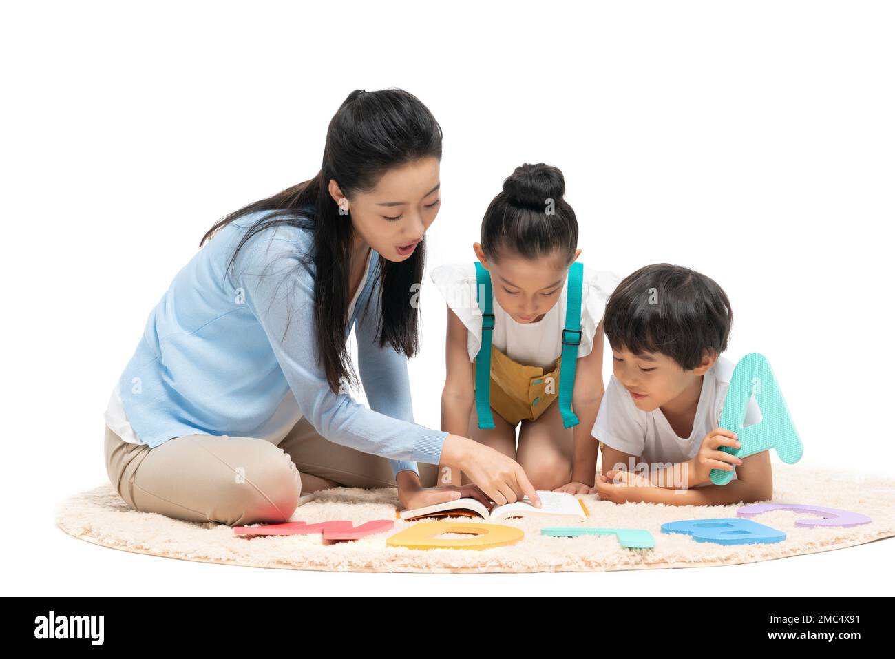 A young female teacher counseling students learning Stock Photo - Alamy