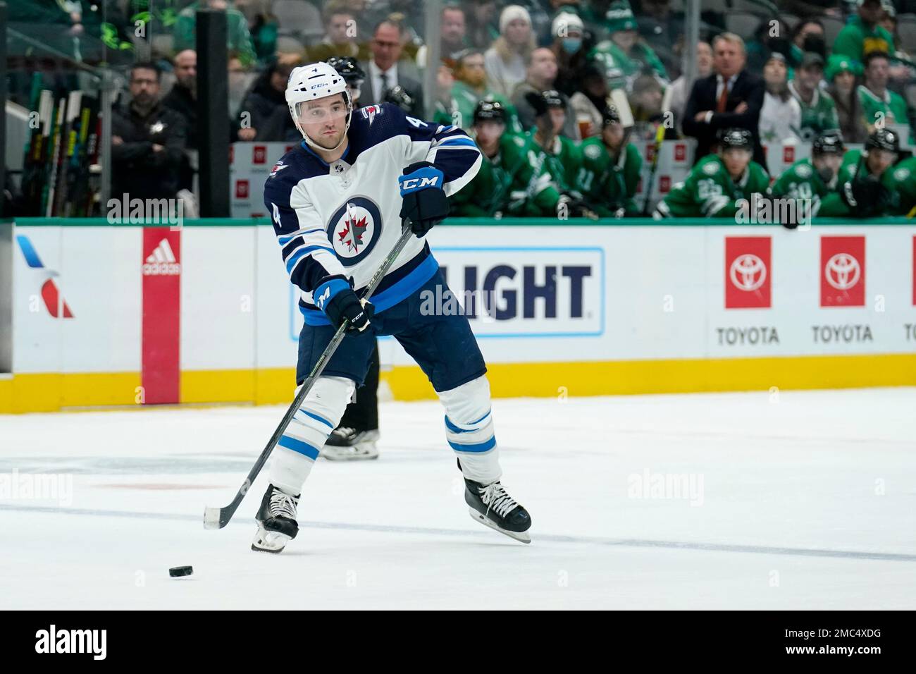 Winnipeg Jets defenseman Neal Pionk handles the puck during an NHL ...