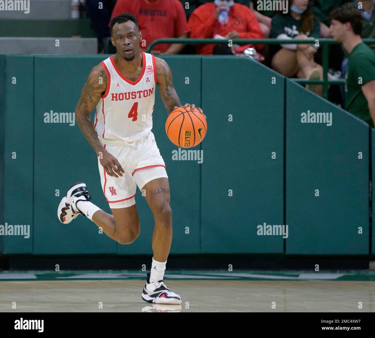 Houston guard Taze Moore (4) dribbles during an NCAA college basketball ...